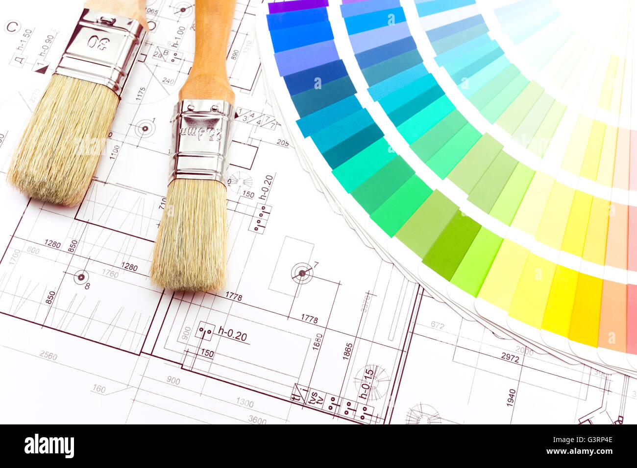 Architect's workplace with house blueprints, color samples and brushes ...