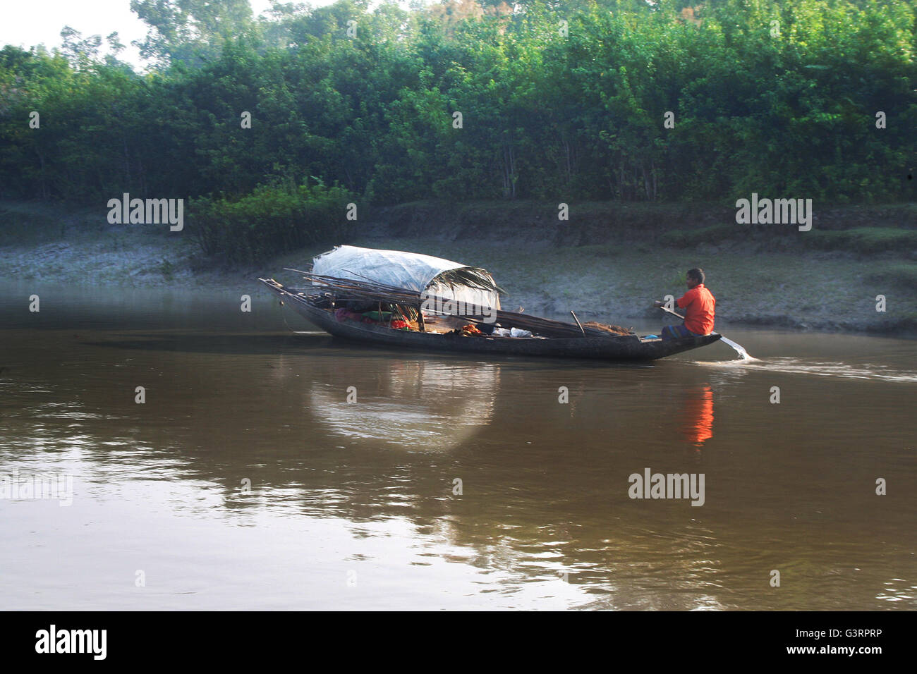 A fishing boat on the river in the Sundarbans. Bagerhat, Bangladesh ...