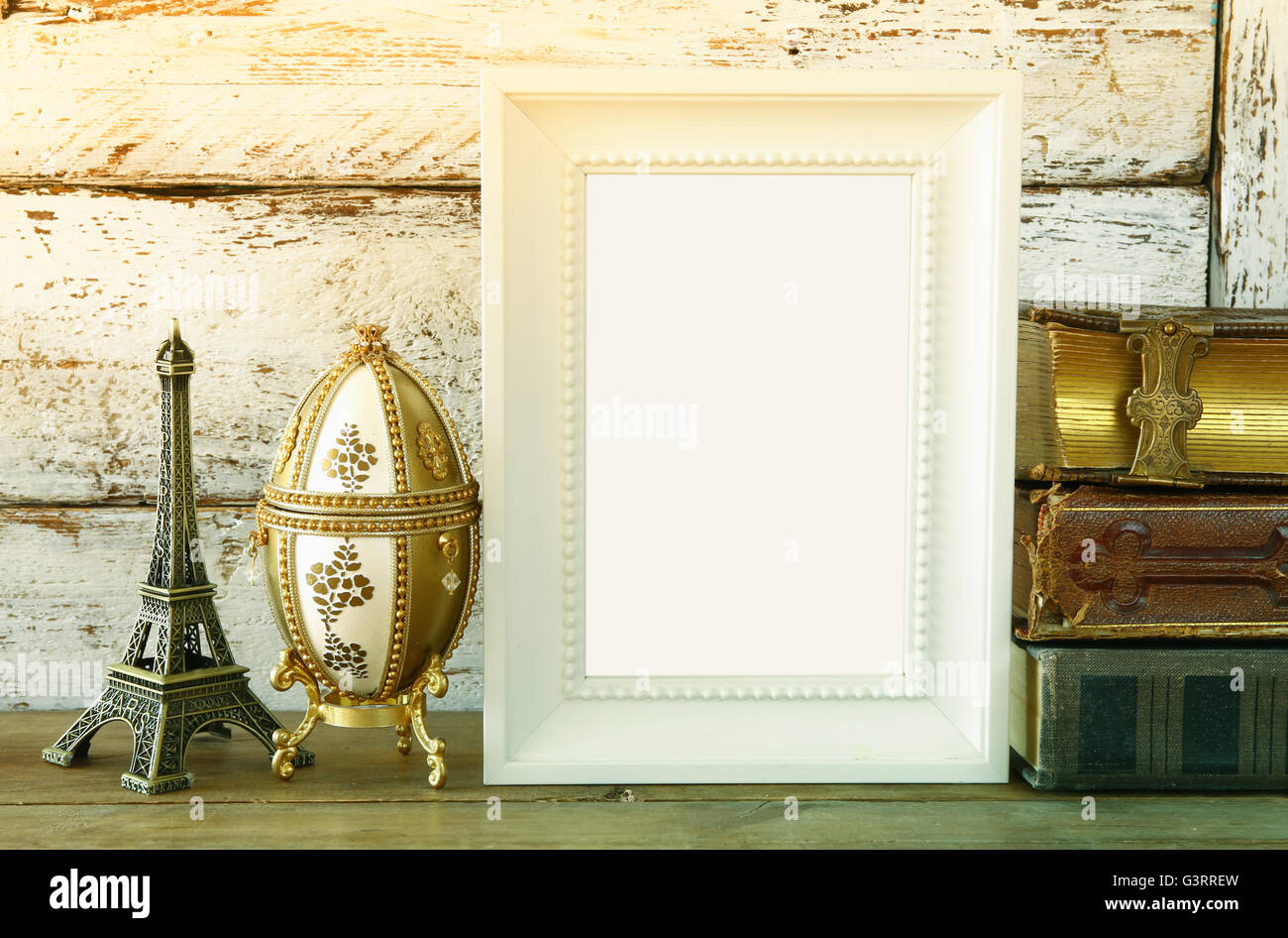 image of blank wooden frame, next to old books. template, ready to put ...