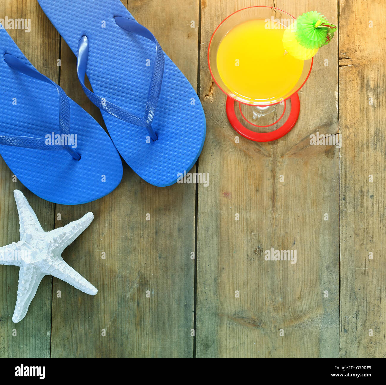 top view image of flip flops, fruit cocktail and starfish on wooden ...