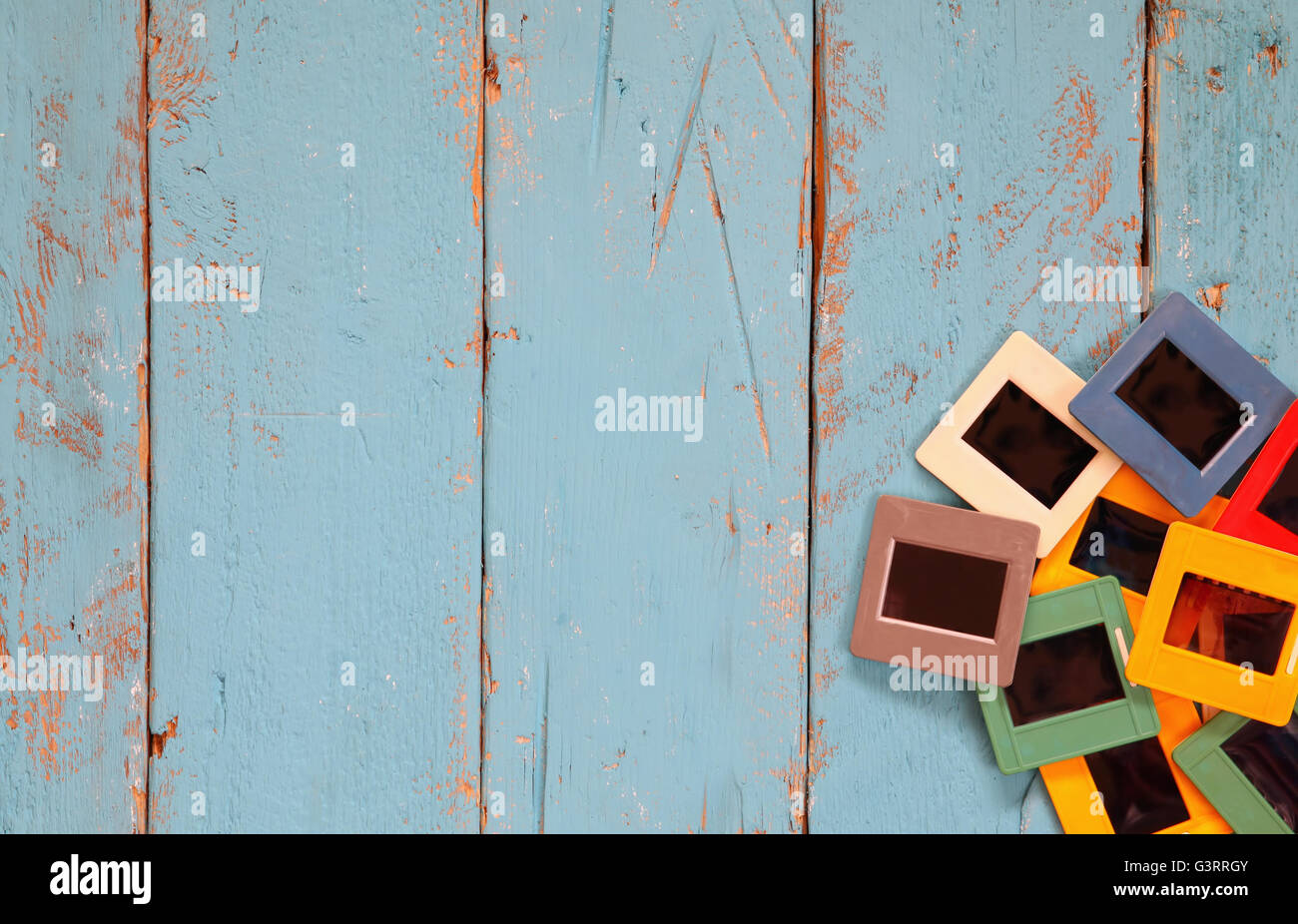top view of old slides frames over wooden blue background. vintage ...