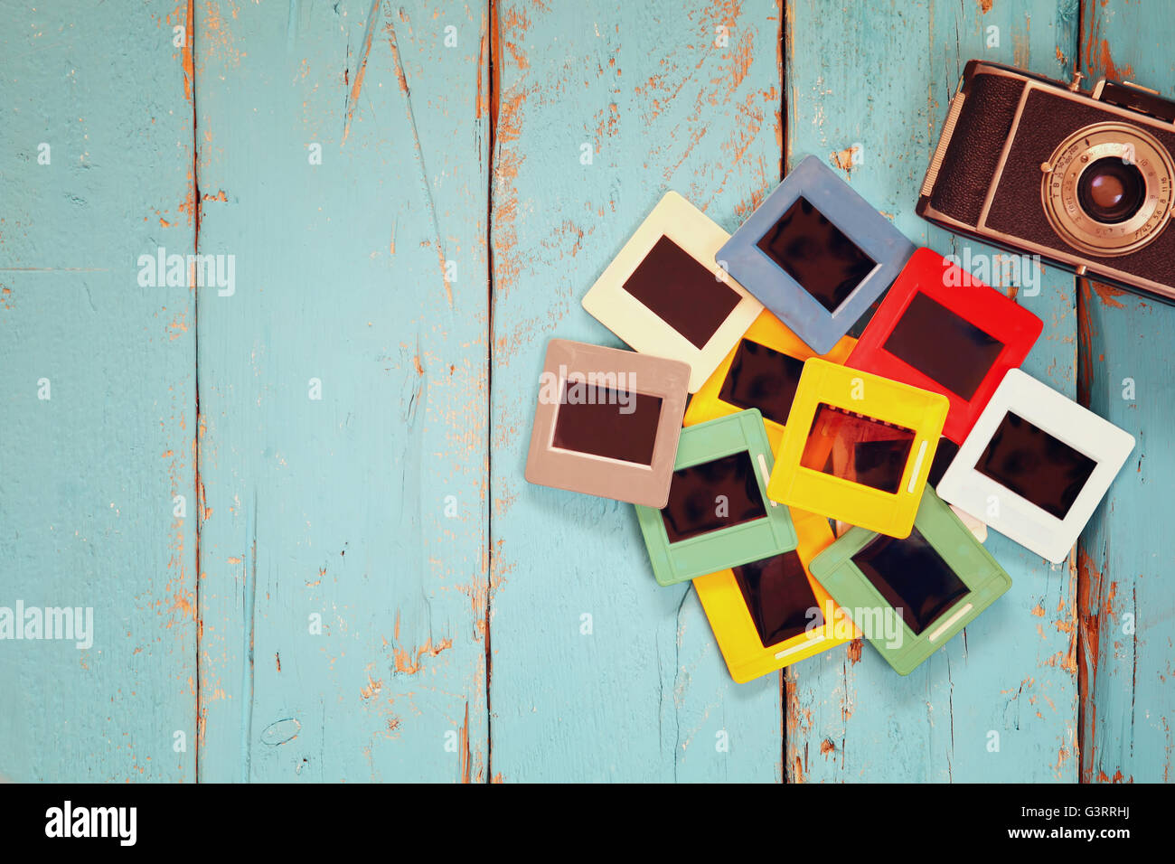 top view of old slides frames over wooden blue background. vintage ...