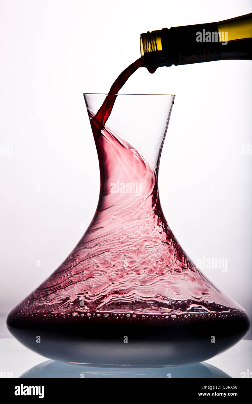 Decanter red wine pouring Stock Photo - Alamy