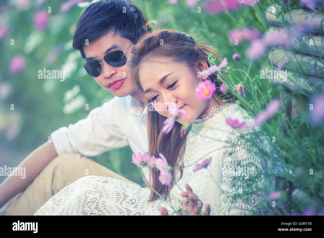 Love and tenderness. Beautiful young loving couple embracing in blossom ...