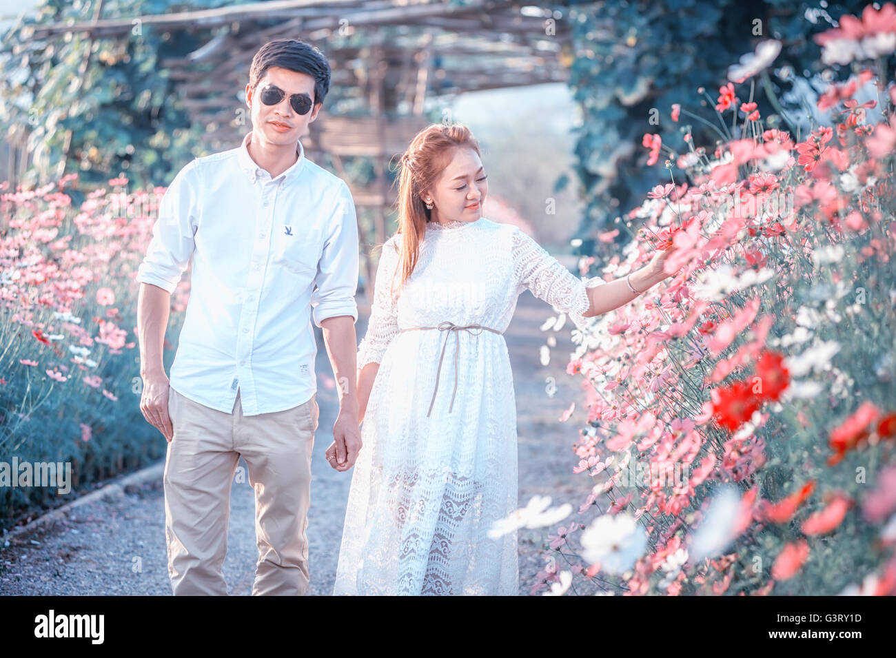 Love and tenderness. Beautiful young loving couple embracing in blossom ...