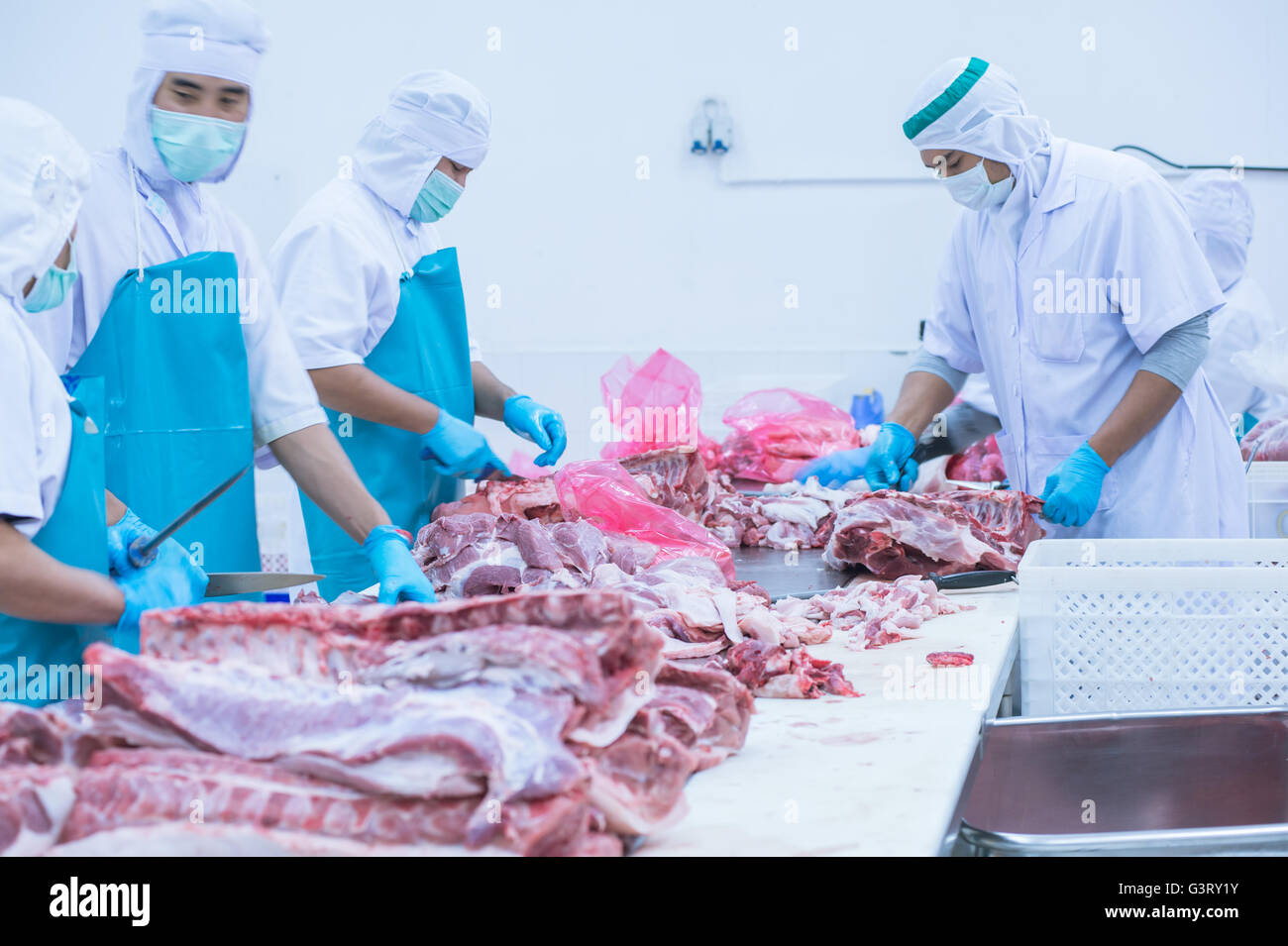 cutting meat slaughterhouse workers in the refrigerator Stock Photo - Alamy
