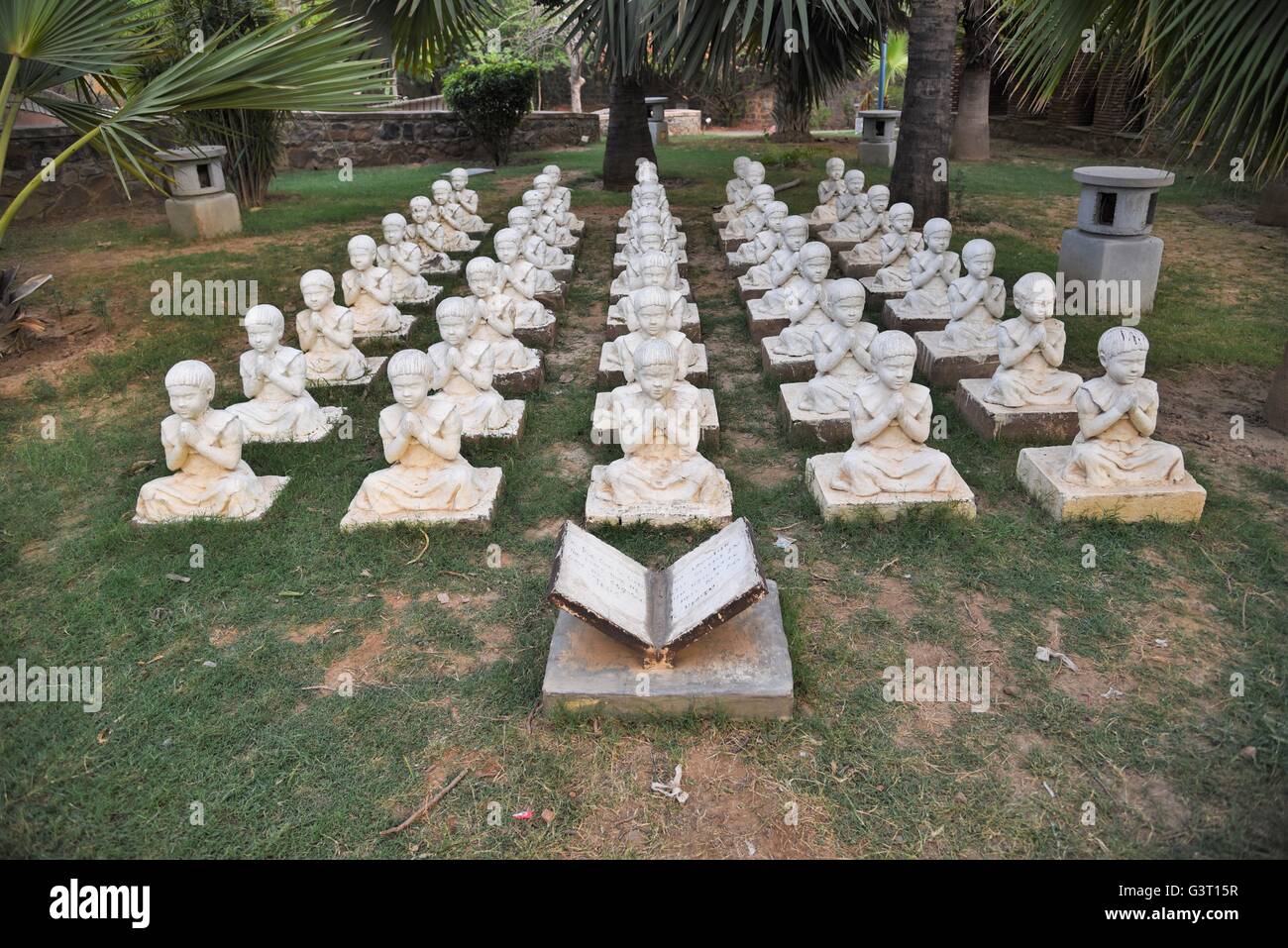 Statues of students sitting with hand folded in a park in New Delhi ...