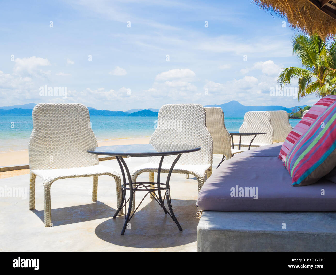 Chairs with table on the beach Stock Photo - Alamy