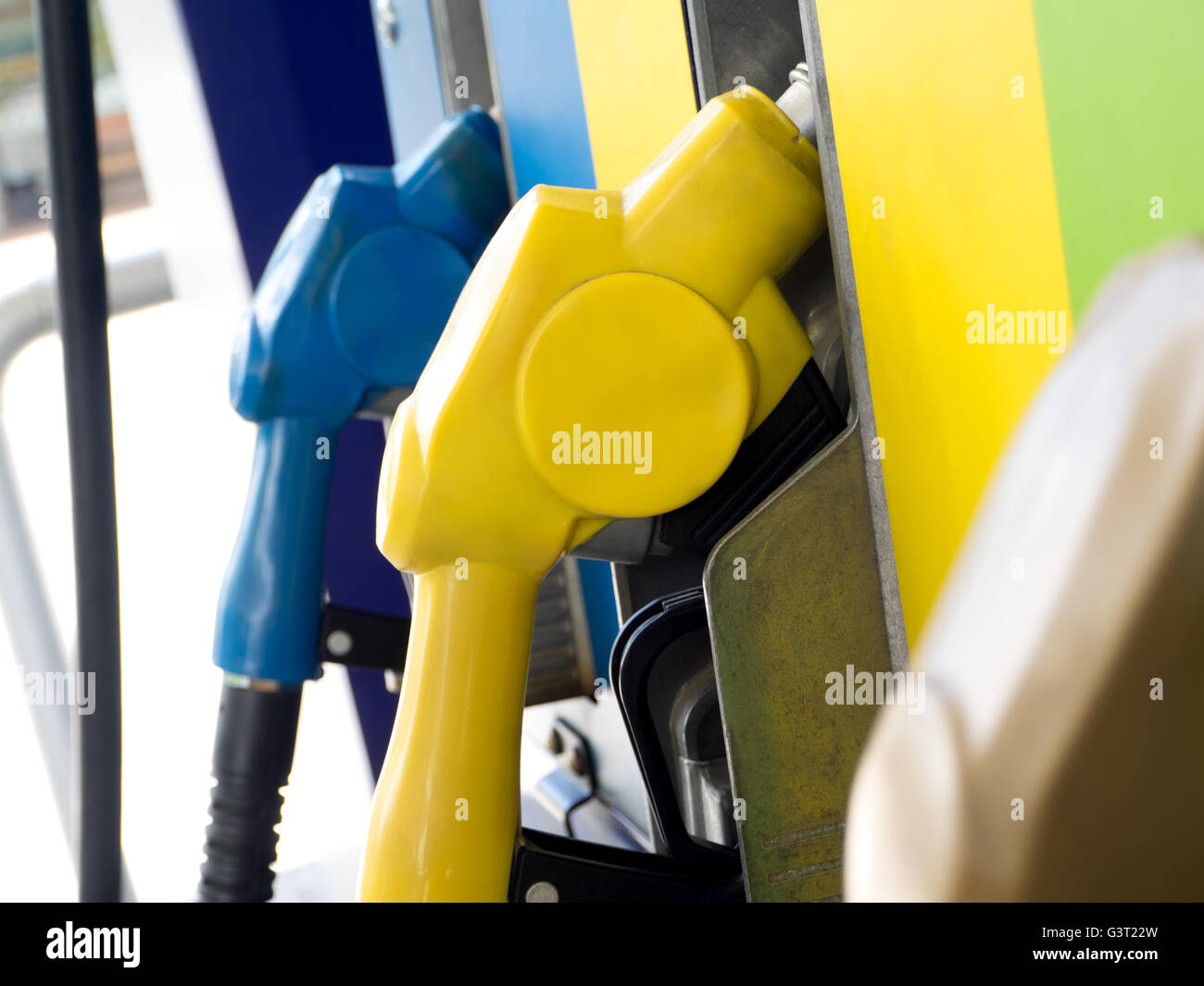 Two different color fuel nozzles in gas station Stock Photo - Alamy
