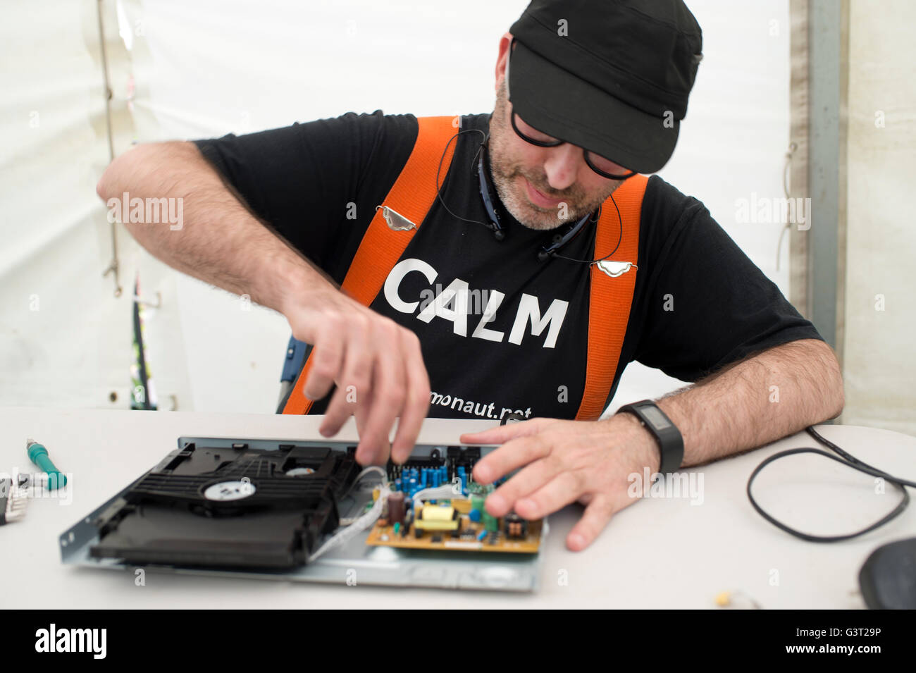 Restart project . A man wearing a t shirt saying 'calm' fixes a broken ...