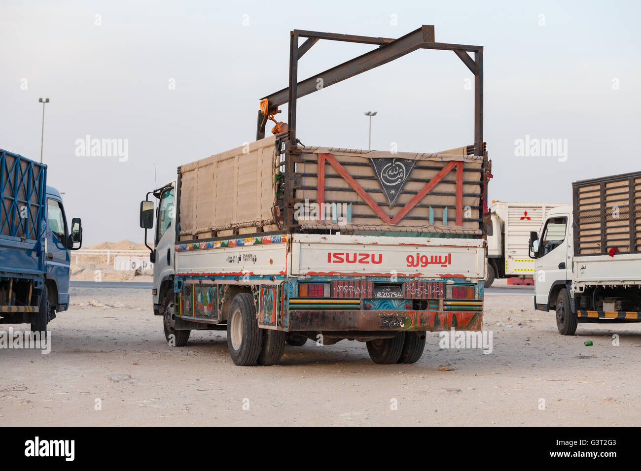 Colourful low loader Isuzu truck with hoist and sides for transporting ...
