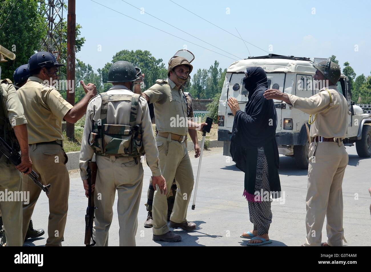 A Kashmiri woman pleads in front of an Indian police officer after her ...