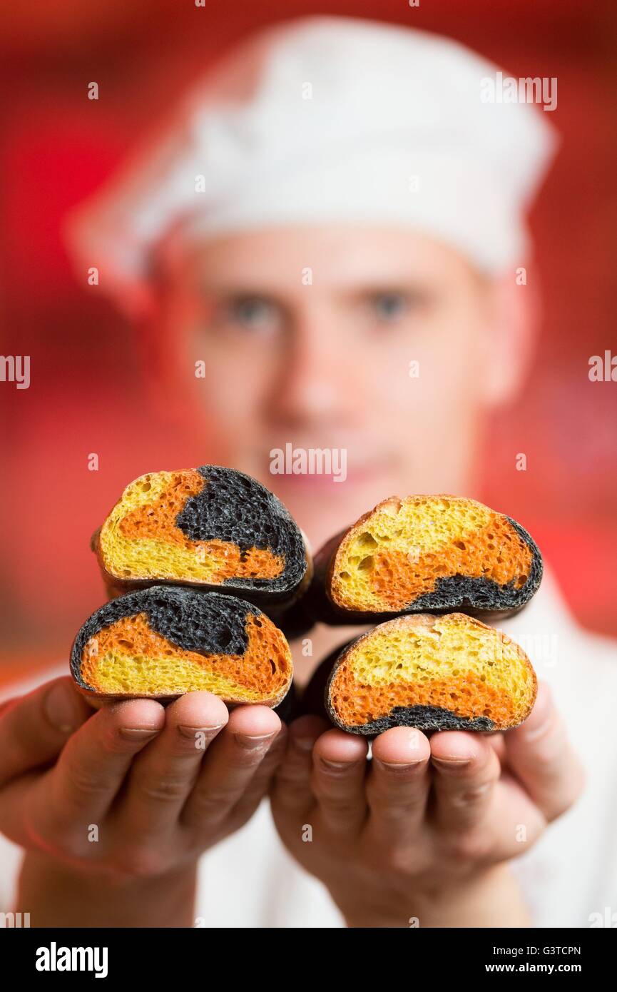 Master baker Marco Simon holds up several European Champion breads in ...