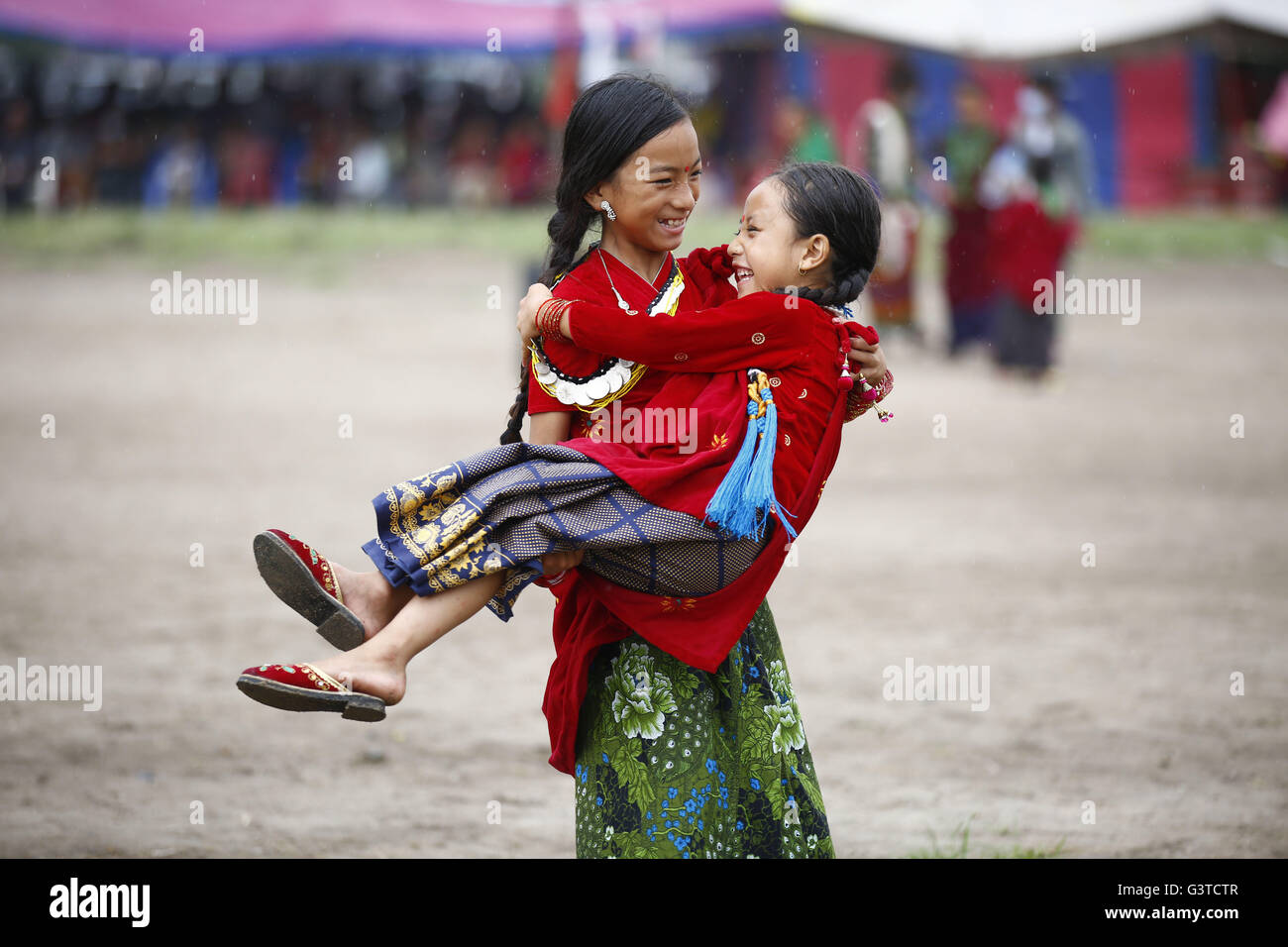 Kathmandu, Nepal. 15th June, 2016. A Nepalese girl is carried by ...