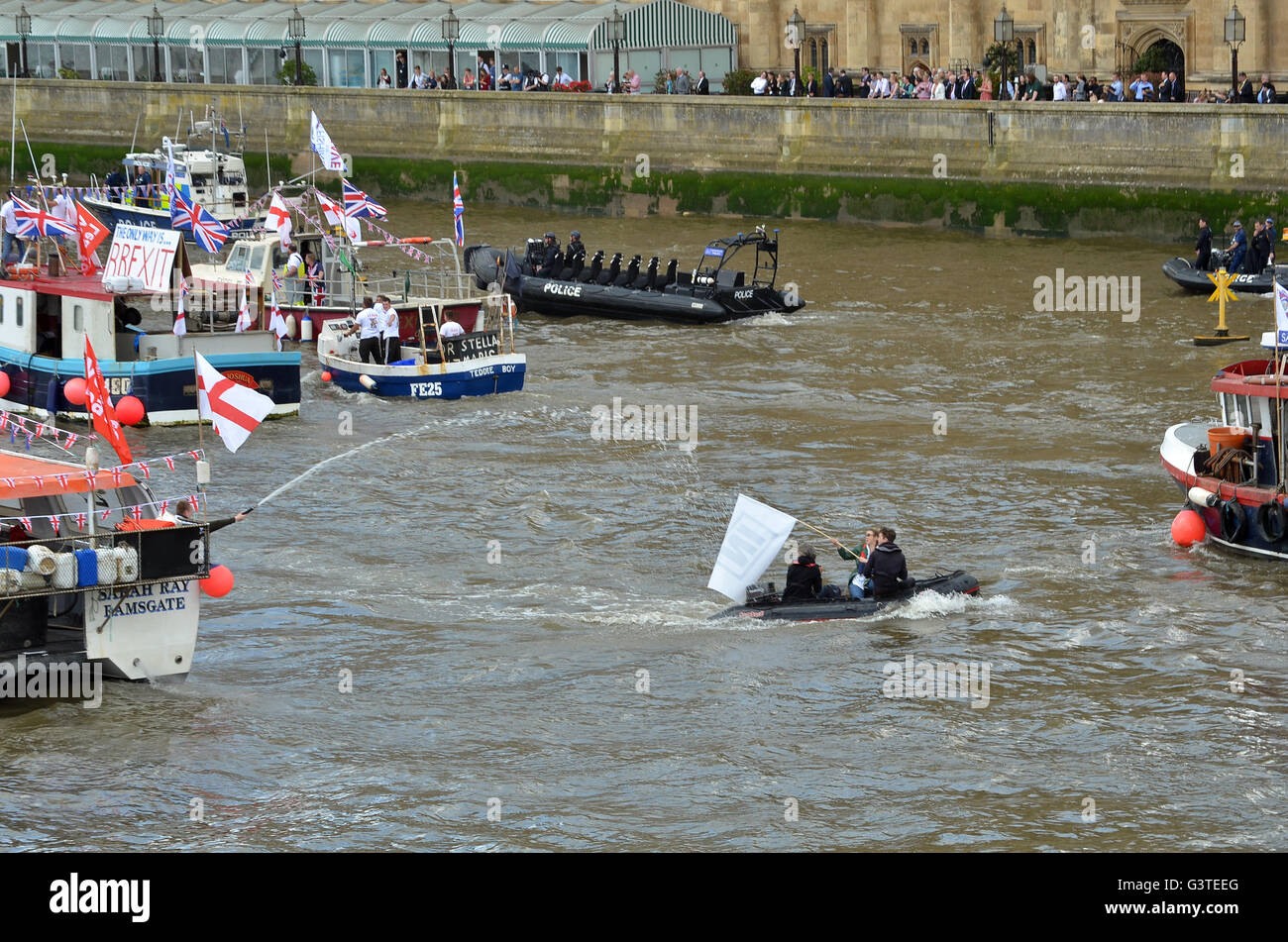 London, UK. 15th June, 2016. A boat aims a stream of water at an IN ...