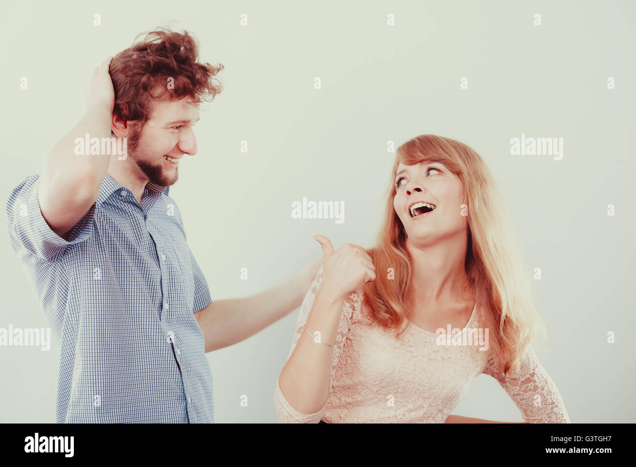 Happy romantic young couple. Smiling friends woman and man in studio ...