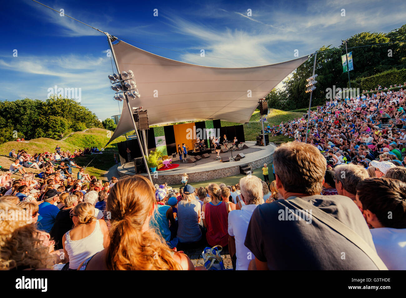 Large audience watching open air performance hi-res stock photography ...