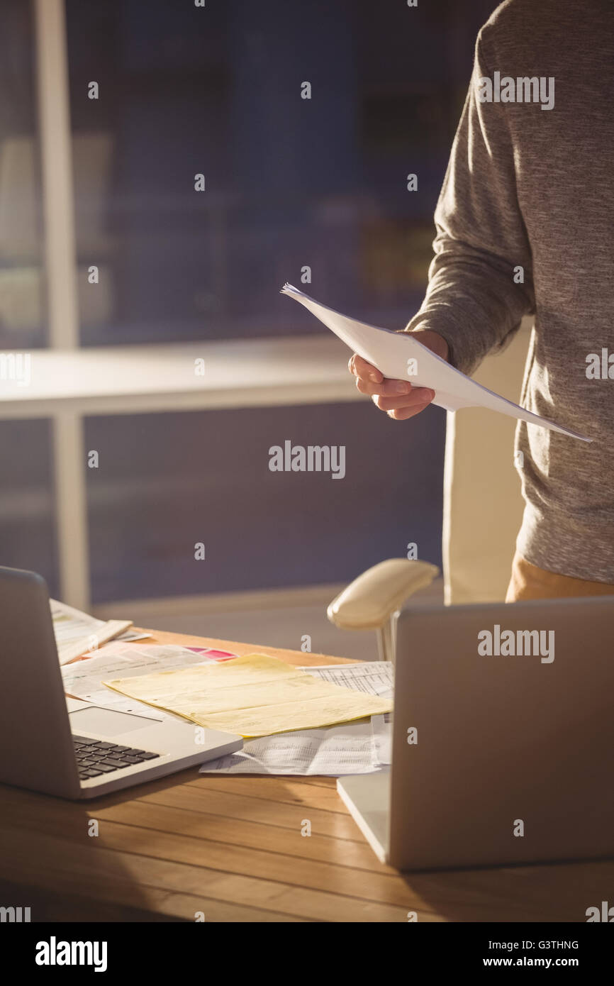 Hipster reading documents Stock Photo - Alamy
