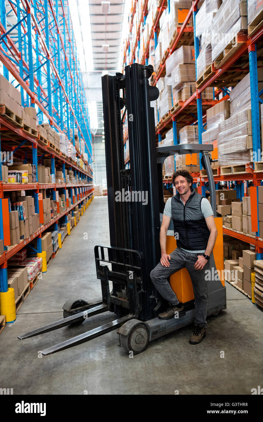 Warehouse worker with forklift Stock Photo - Alamy