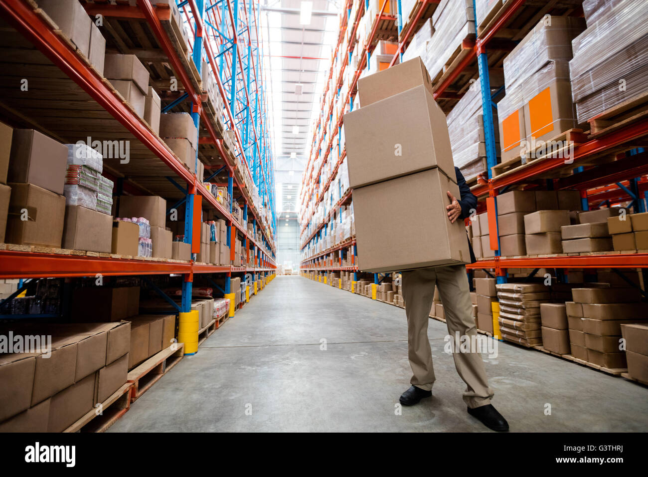 Worker carrying boxes Stock Photo - Alamy