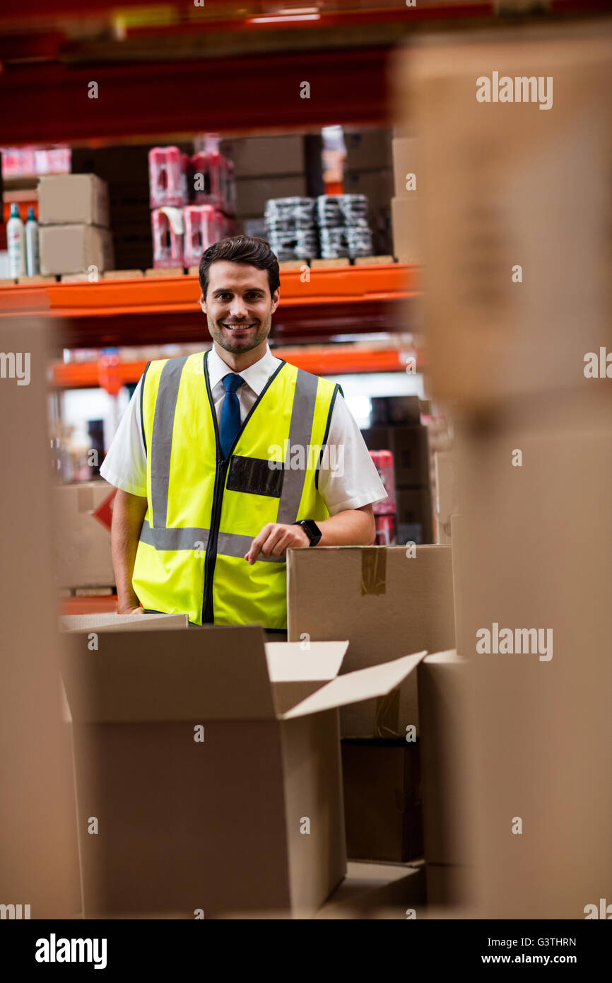 Warehouse manager standing with boxes Stock Photo - Alamy