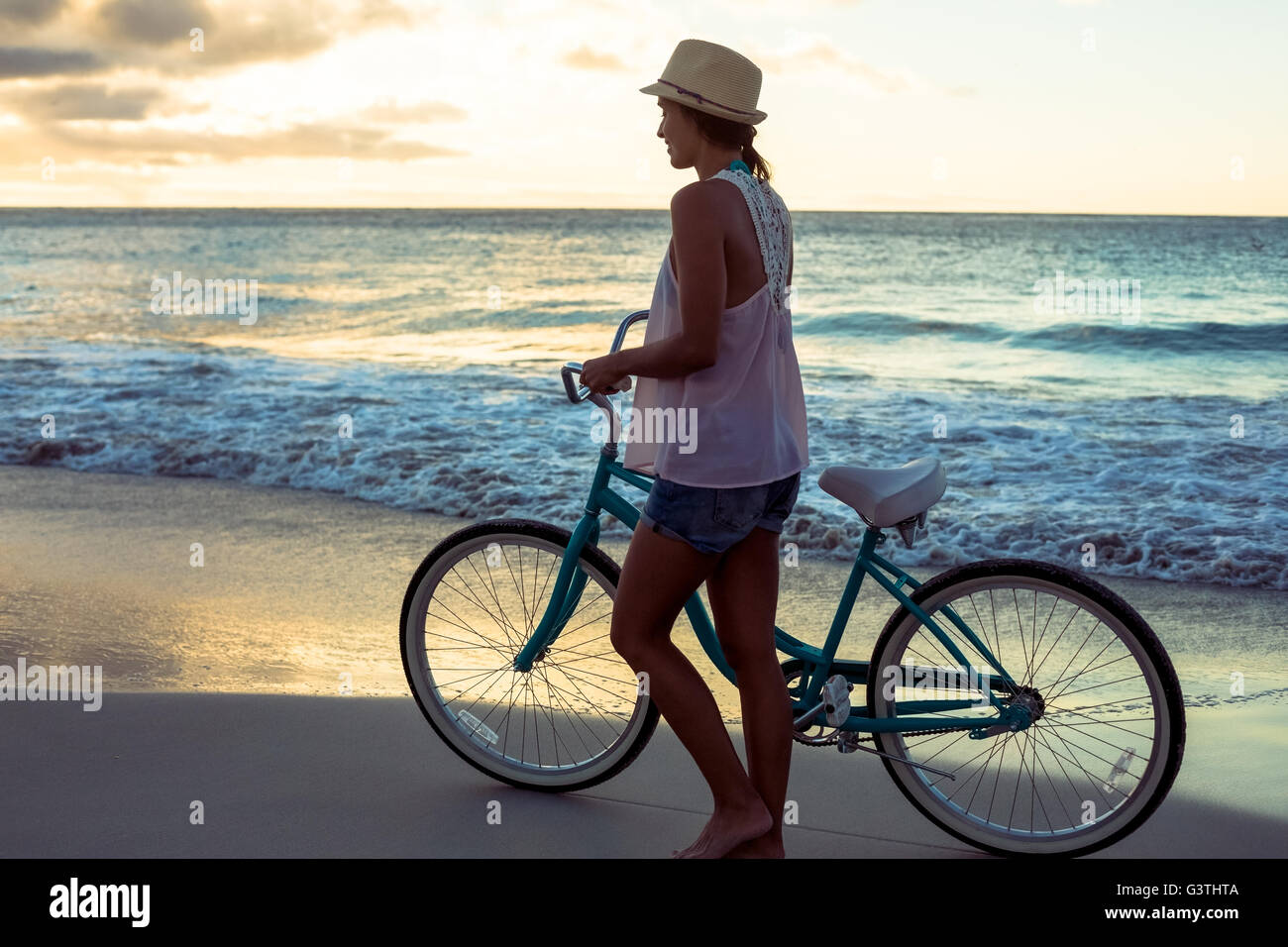 Woman walking her bicycle hi-res stock photography and images - Alamy