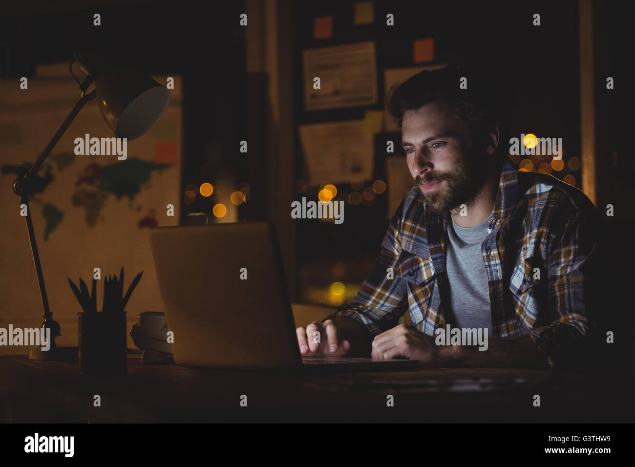 Concentrated young businessman using computer at office desk Stock ...