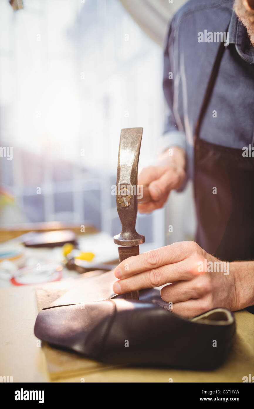 Close up of cobbler making a shoe with a hammer Stock Photo - Alamy