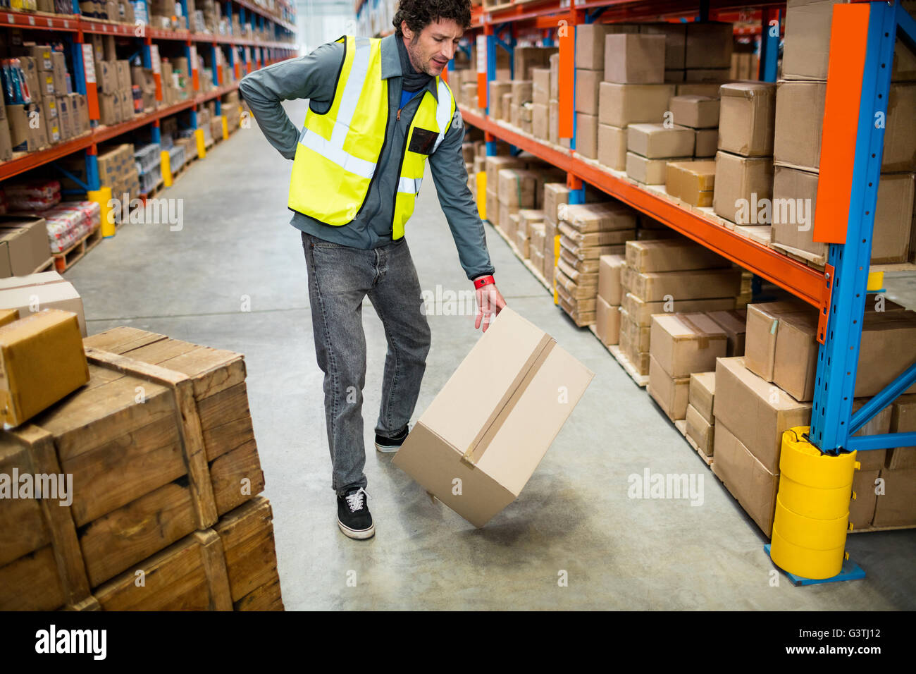 Worker warehouse has back pain Stock Photo - Alamy