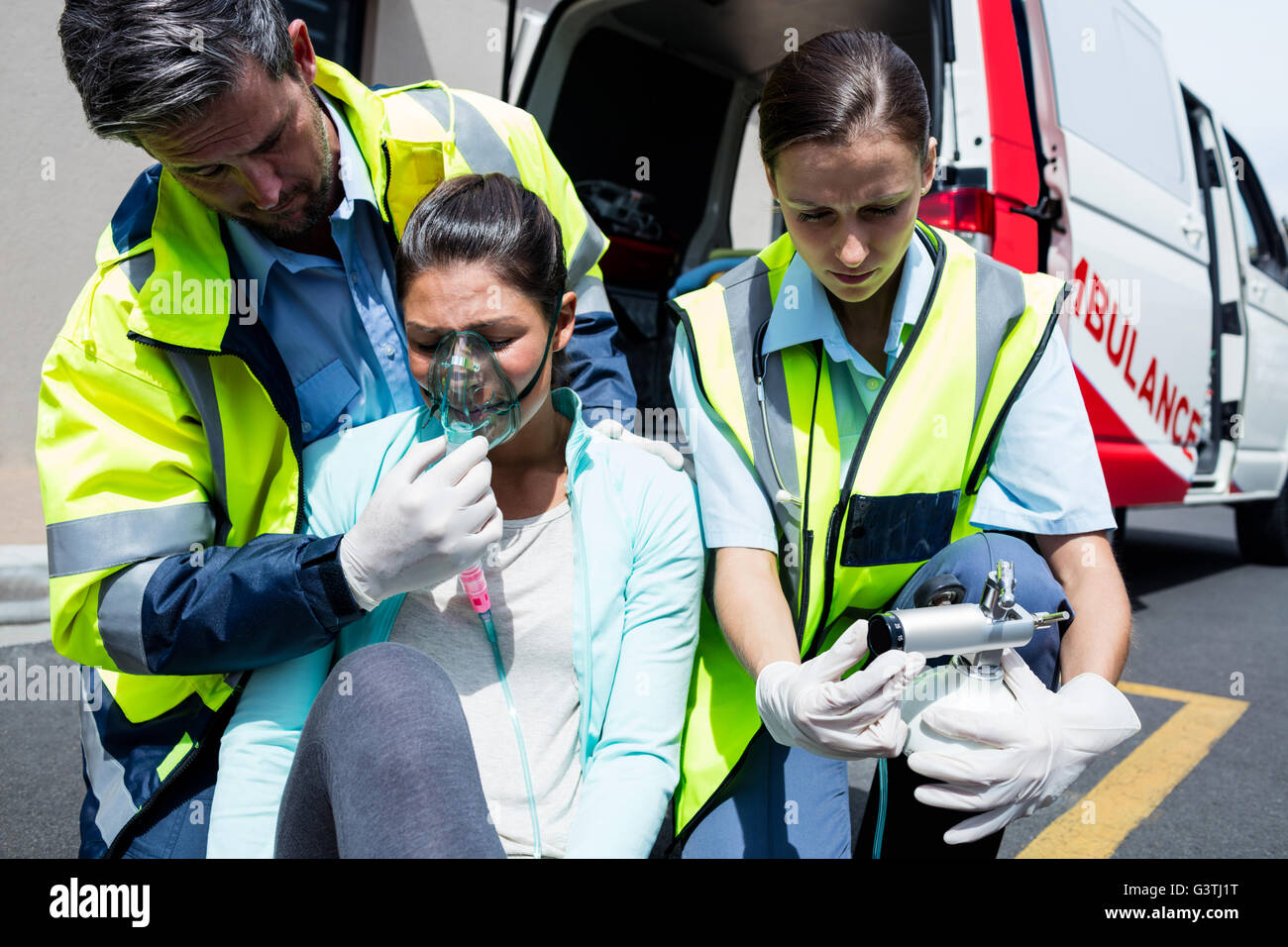 Ambulance men taking care of injured people Stock Photo - Alamy