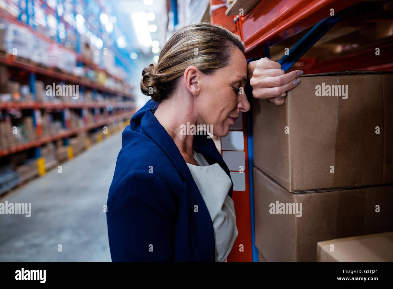 Close up of exhausted warehouse manager`leaning on a box Stock Photo ...