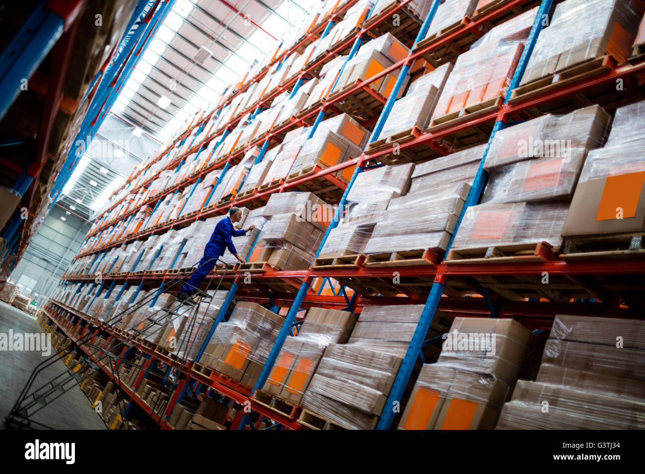 Man worker checking a pallet on the stairs Stock Photo - Alamy