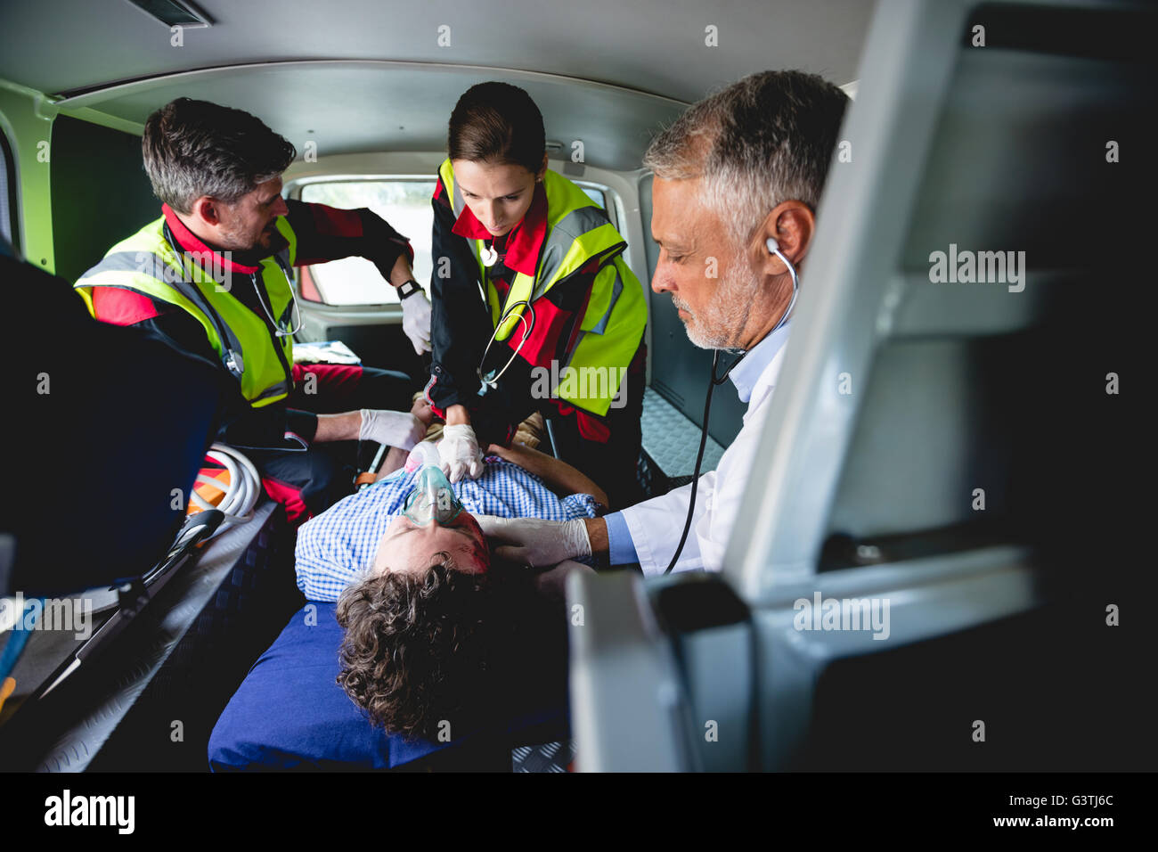 Injured man with ambulance men Stock Photo - Alamy