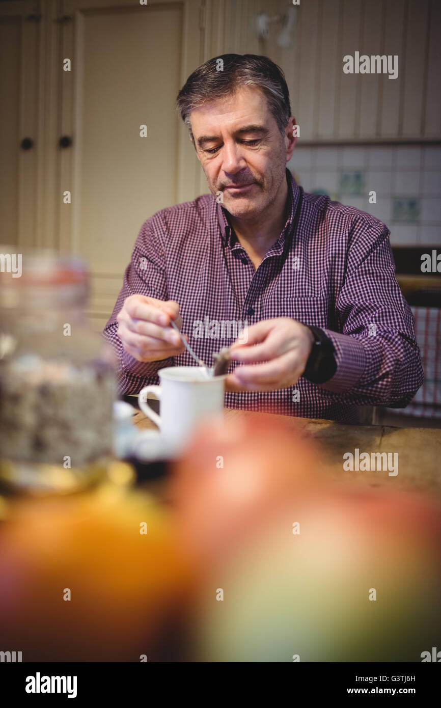 Mature man preparing tea Stock Photo - Alamy