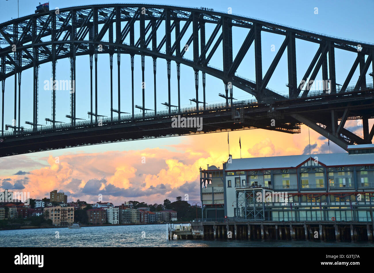 Grand arch of the Sydney Harbour Bridge and surrounding wharf ...