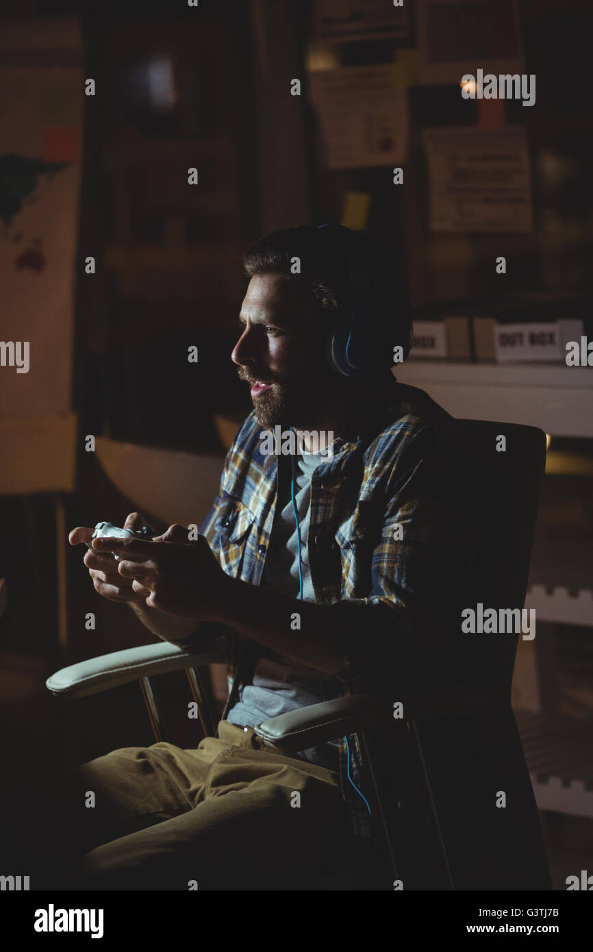 Businessman playing computer games at night Stock Photo - Alamy