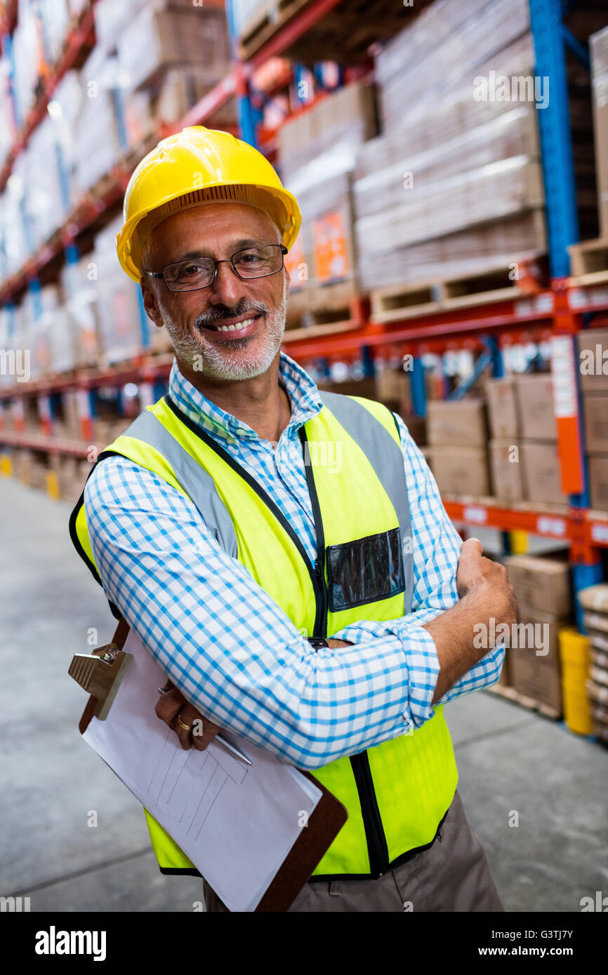 Portrait of a smiling warehouse worker with a clipboard Stock Photo - Alamy