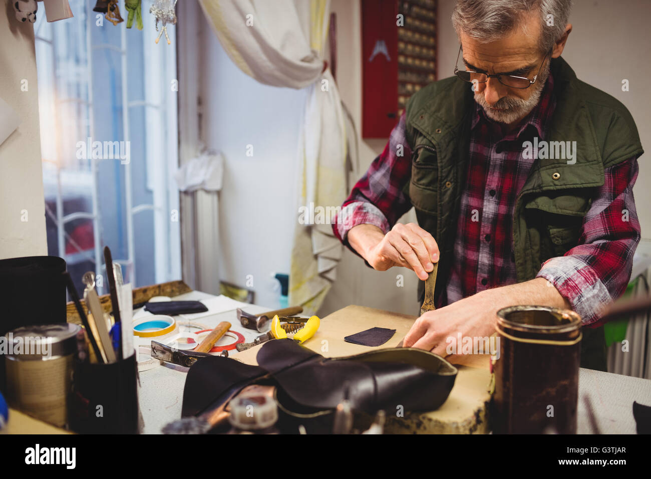 Cobbler putting wax on materials Stock Photo - Alamy