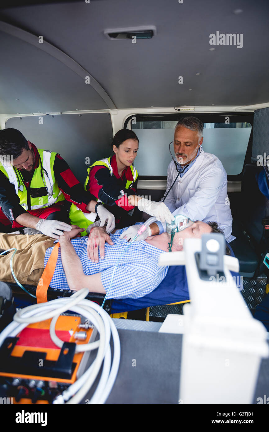 Injured man with ambulance men Stock Photo - Alamy