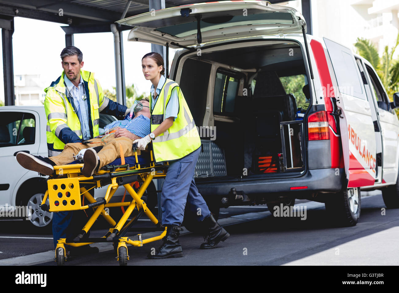 Injured man with ambulance men Stock Photo - Alamy