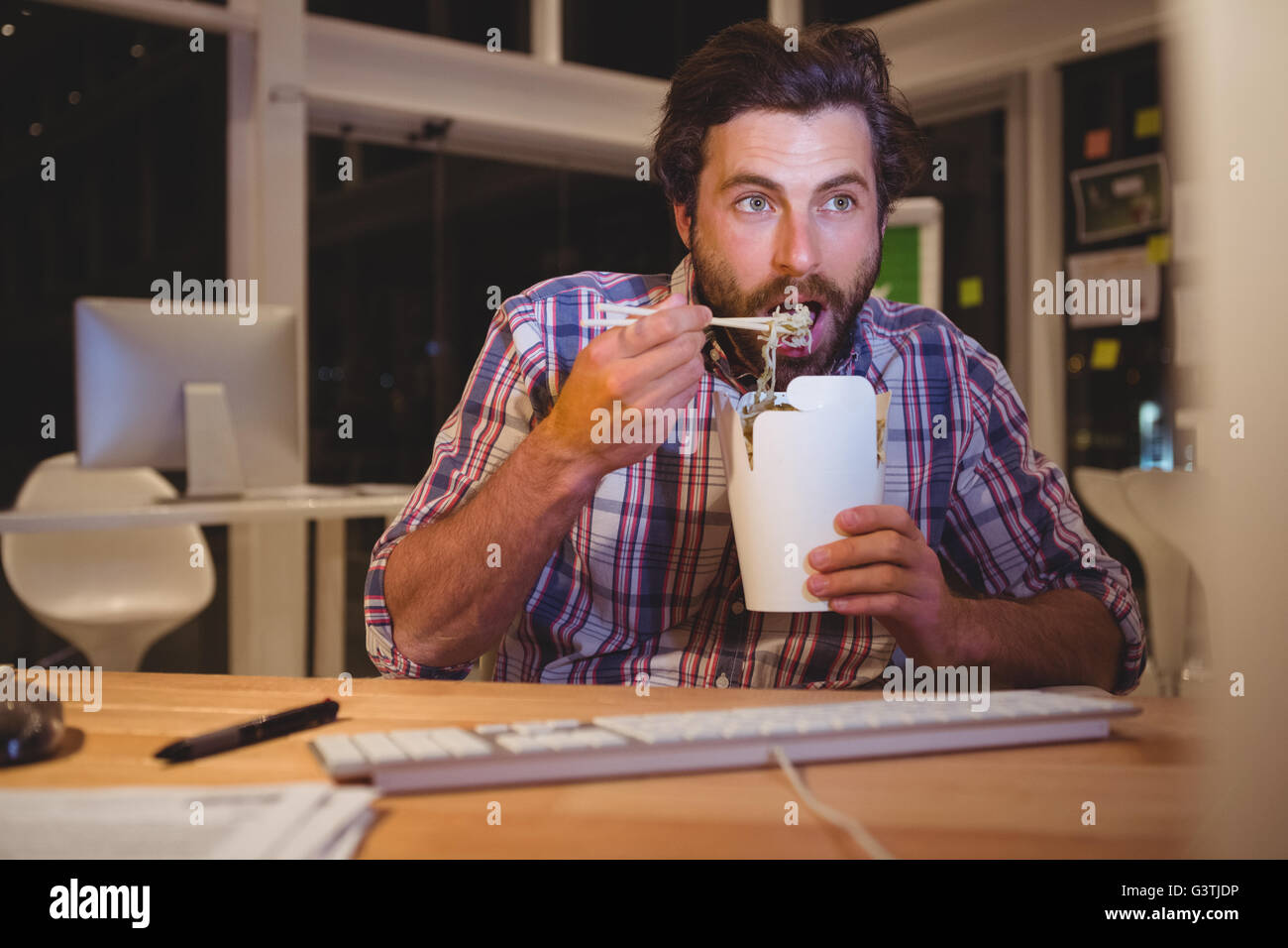 Eating at office desk man tense hi-res stock photography and images - Alamy