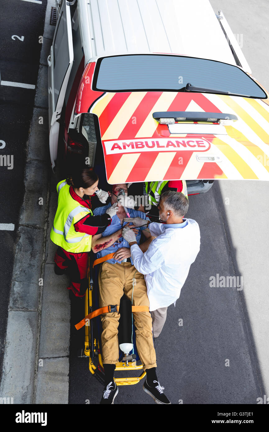 Injured man with ambulance men Stock Photo - Alamy