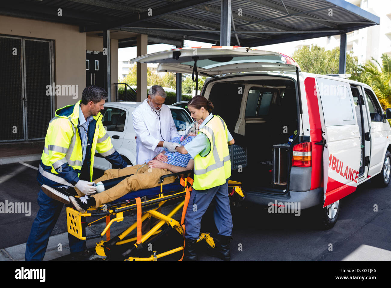 Injured man with ambulance men Stock Photo - Alamy