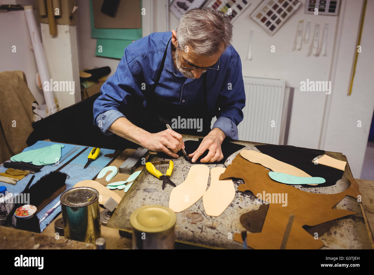 High angle view of cobbler making shoes Stock Photo - Alamy