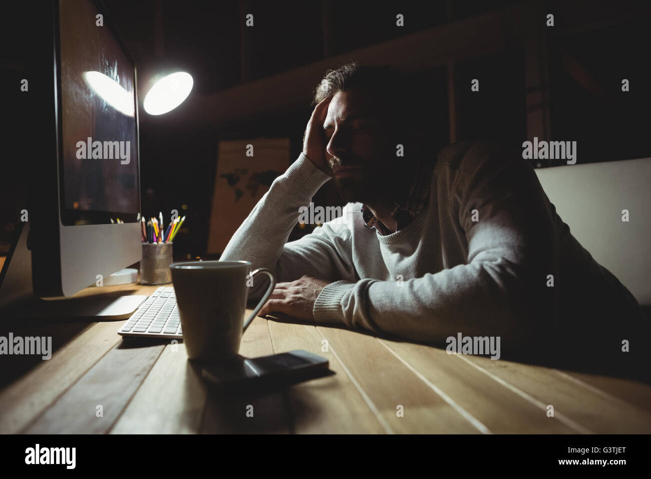 Sleepy businessman watching his computer Stock Photo - Alamy