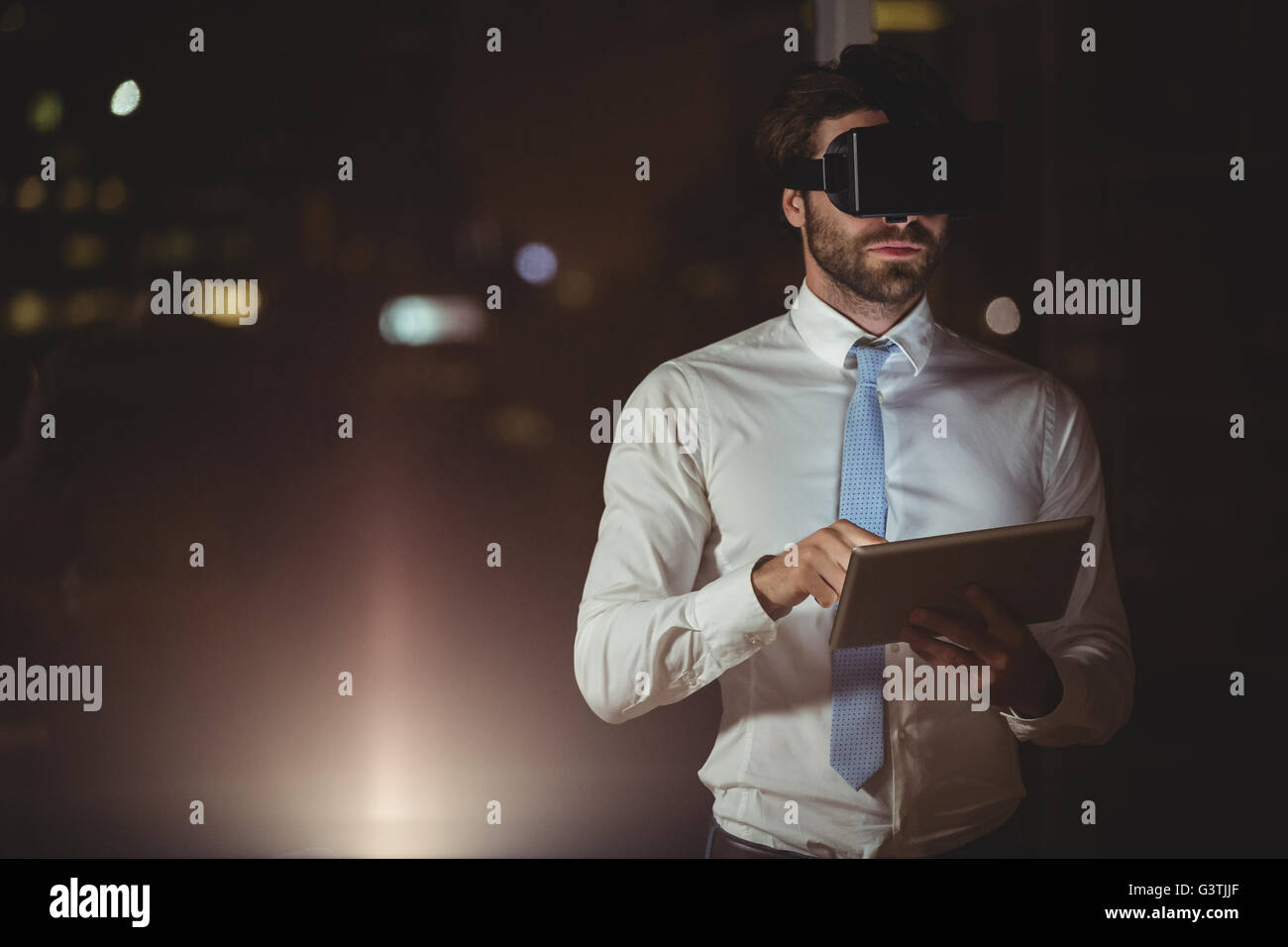 Businessman using technology at night Stock Photo - Alamy
