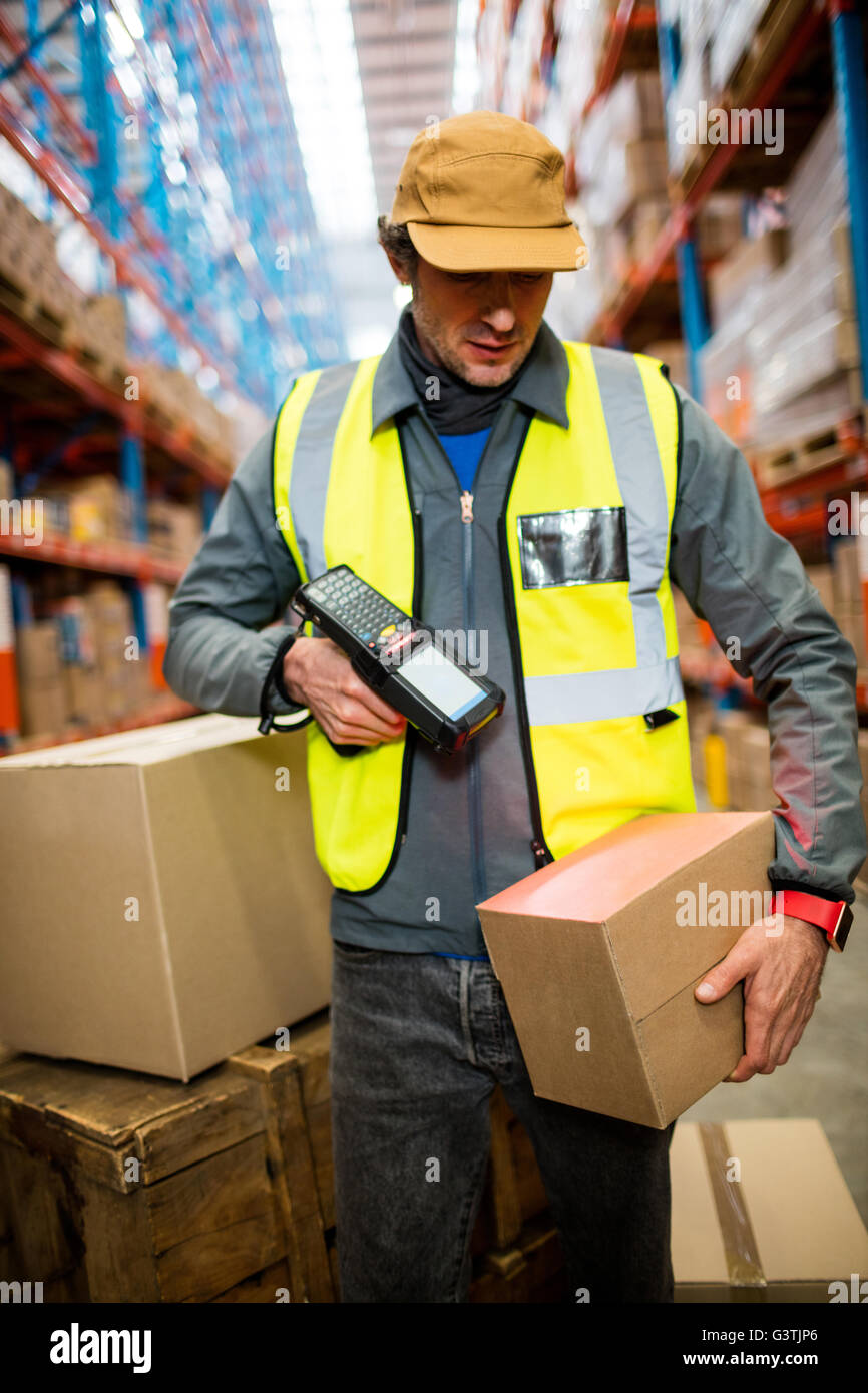 Warehouse worker using hand scanner Stock Photo - Alamy