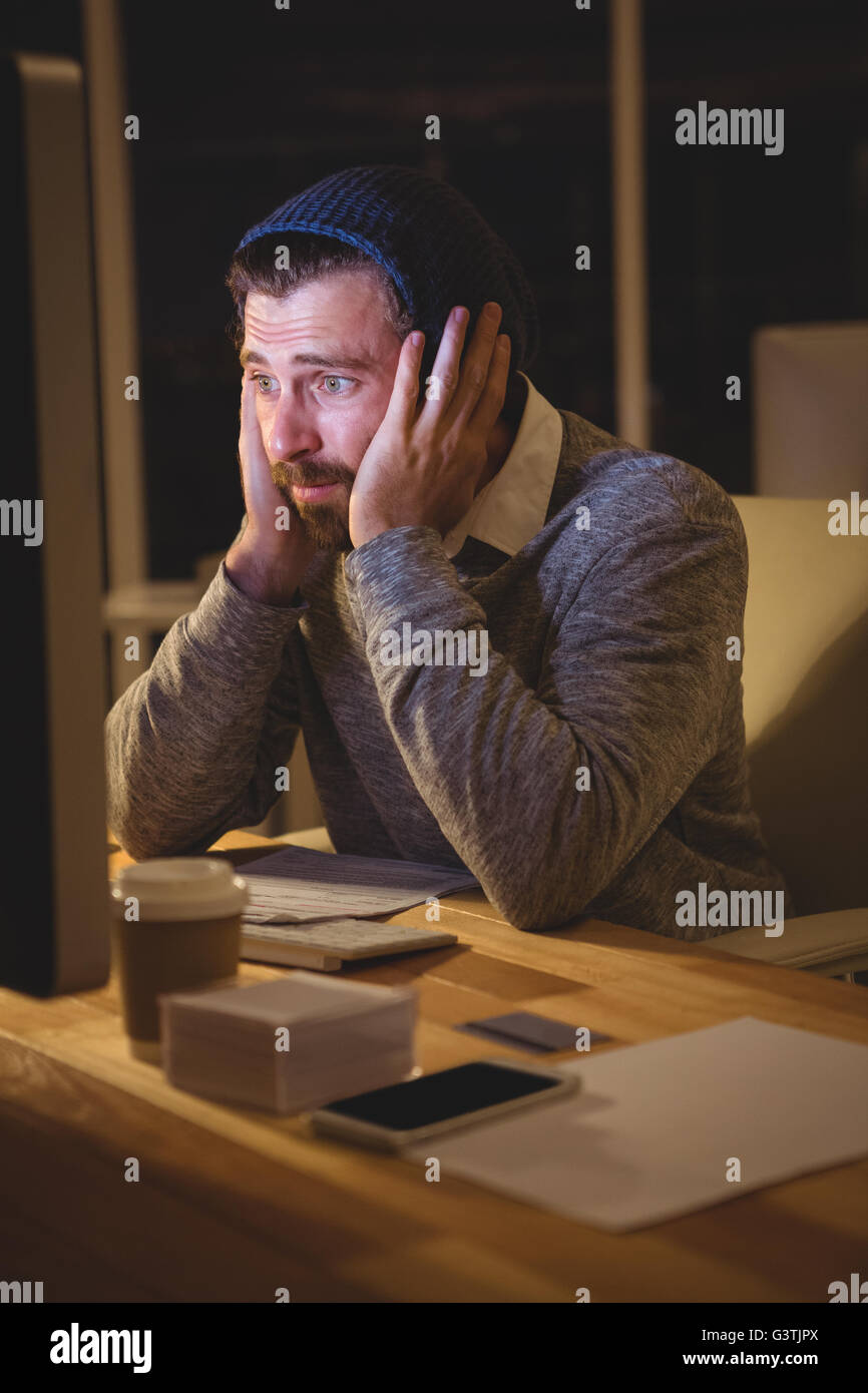 Hipster looking at computer Stock Photo - Alamy