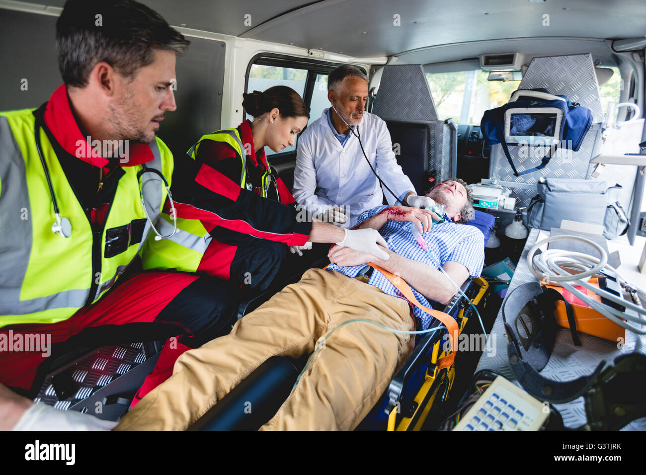Injured man with ambulance men Stock Photo - Alamy