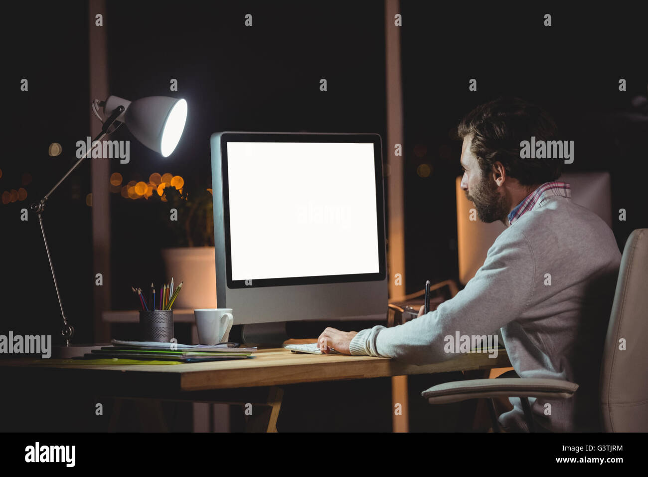 Concentrated man front of computer Stock Photo - Alamy
